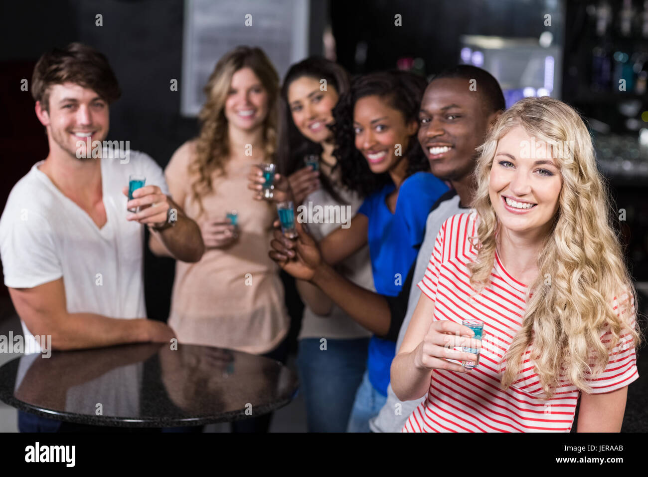 Group of friends having shots Stock Photo - Alamy