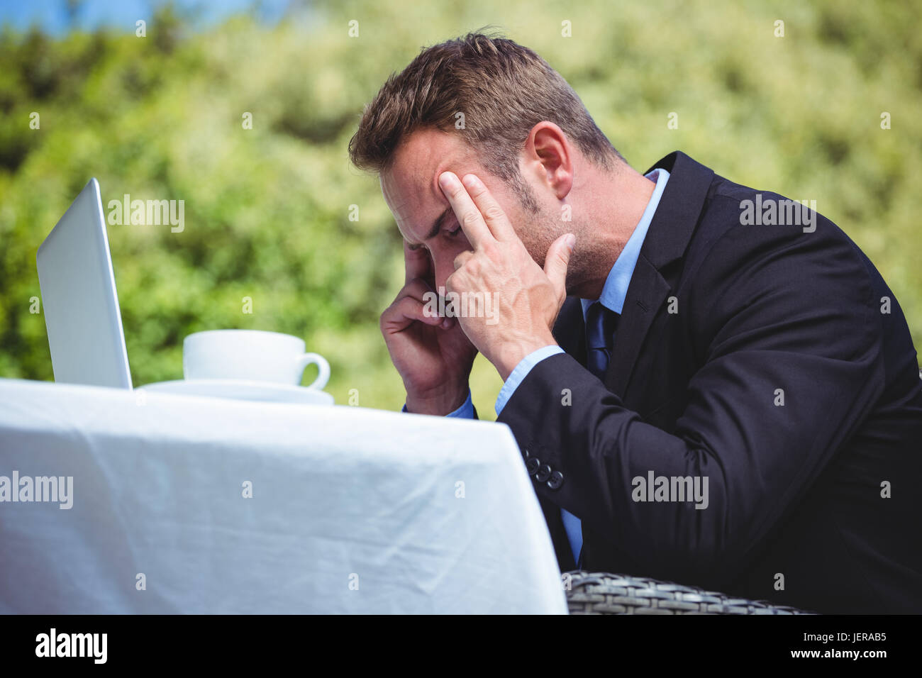 Nervous businessman working with laptop Stock Photo - Alamy