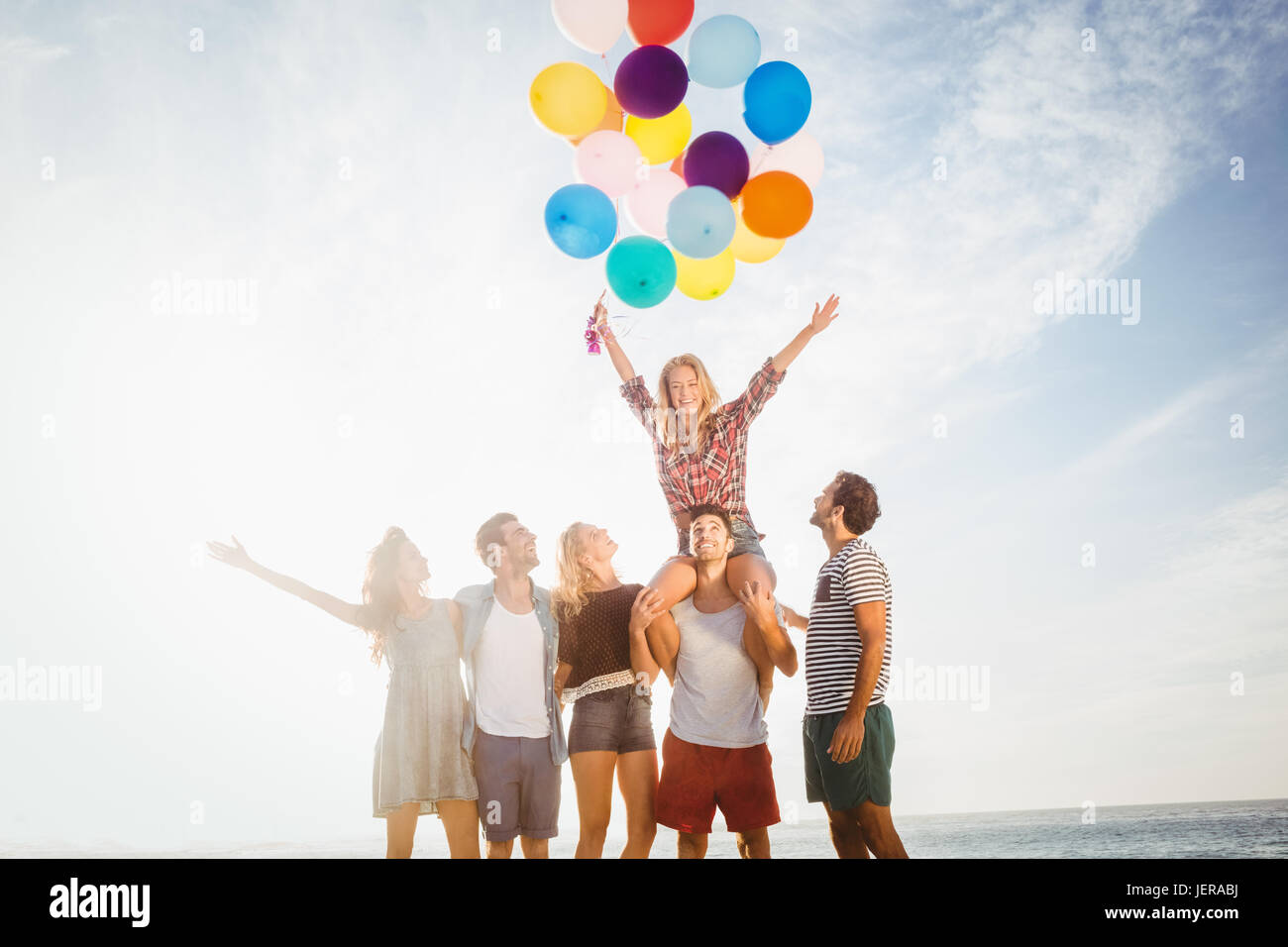 Portrait of friends holding balloon Stock Photo - Alamy