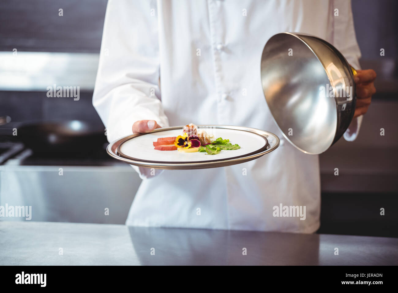 Chef raising a bell of a dish Stock Photo - Alamy