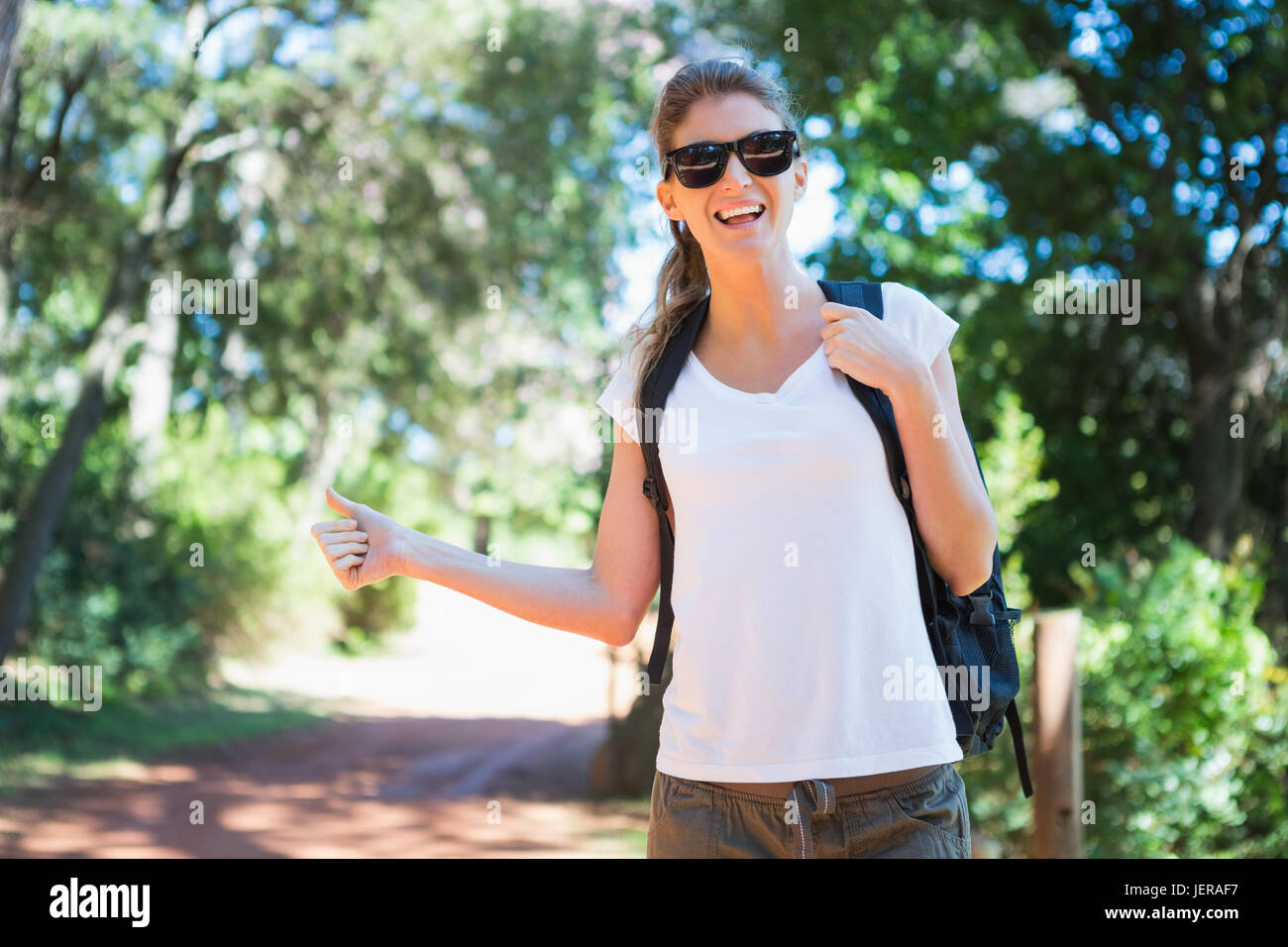 Portrait of woman hitch hiking Stock Photo - Alamy