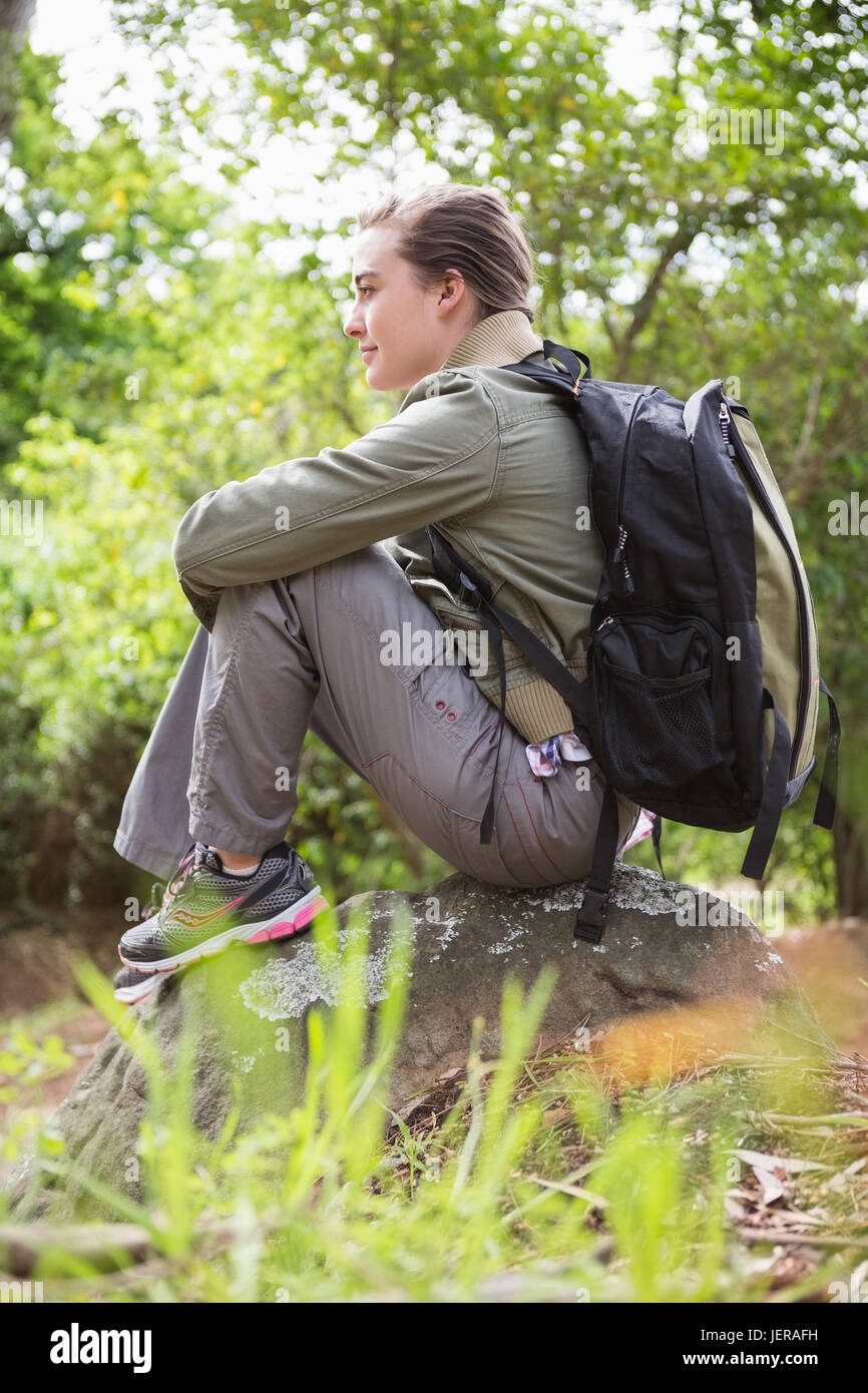 Woman sitting on a stone Stock Photo - Alamy