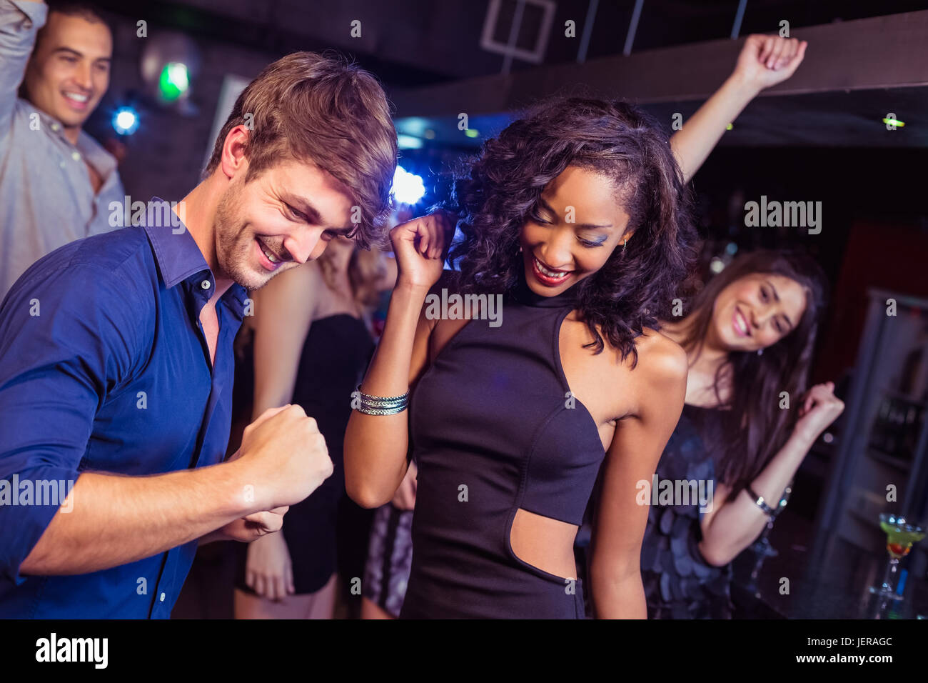 Happy friends dancing together Stock Photo - Alamy