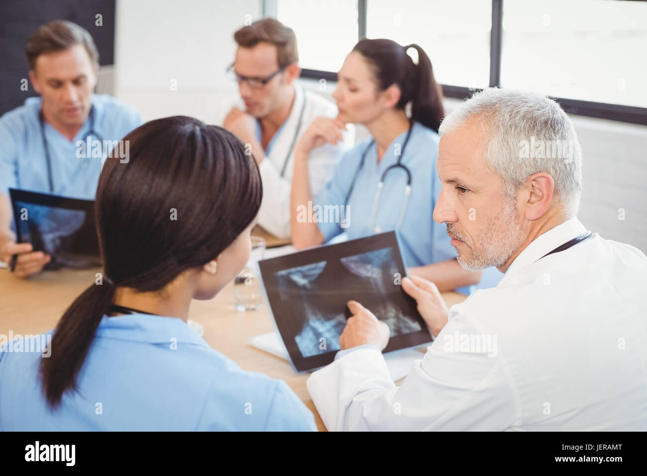 Doctors examining an x-ray report Stock Photo - Alamy