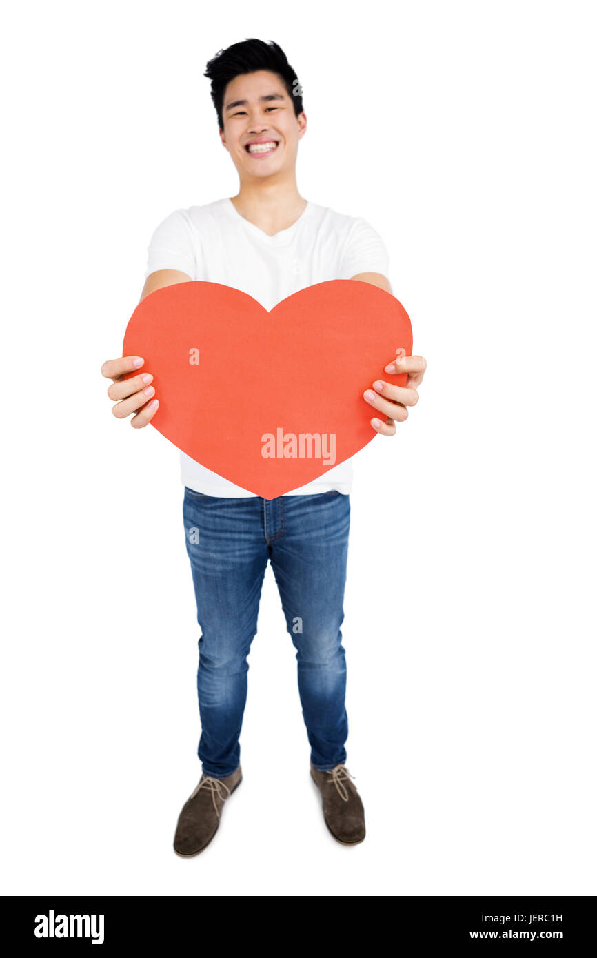 Young man holding heart shape Stock Photo - Alamy