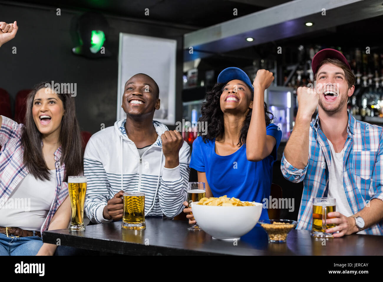 Happy friends watching sport Stock Photo - Alamy