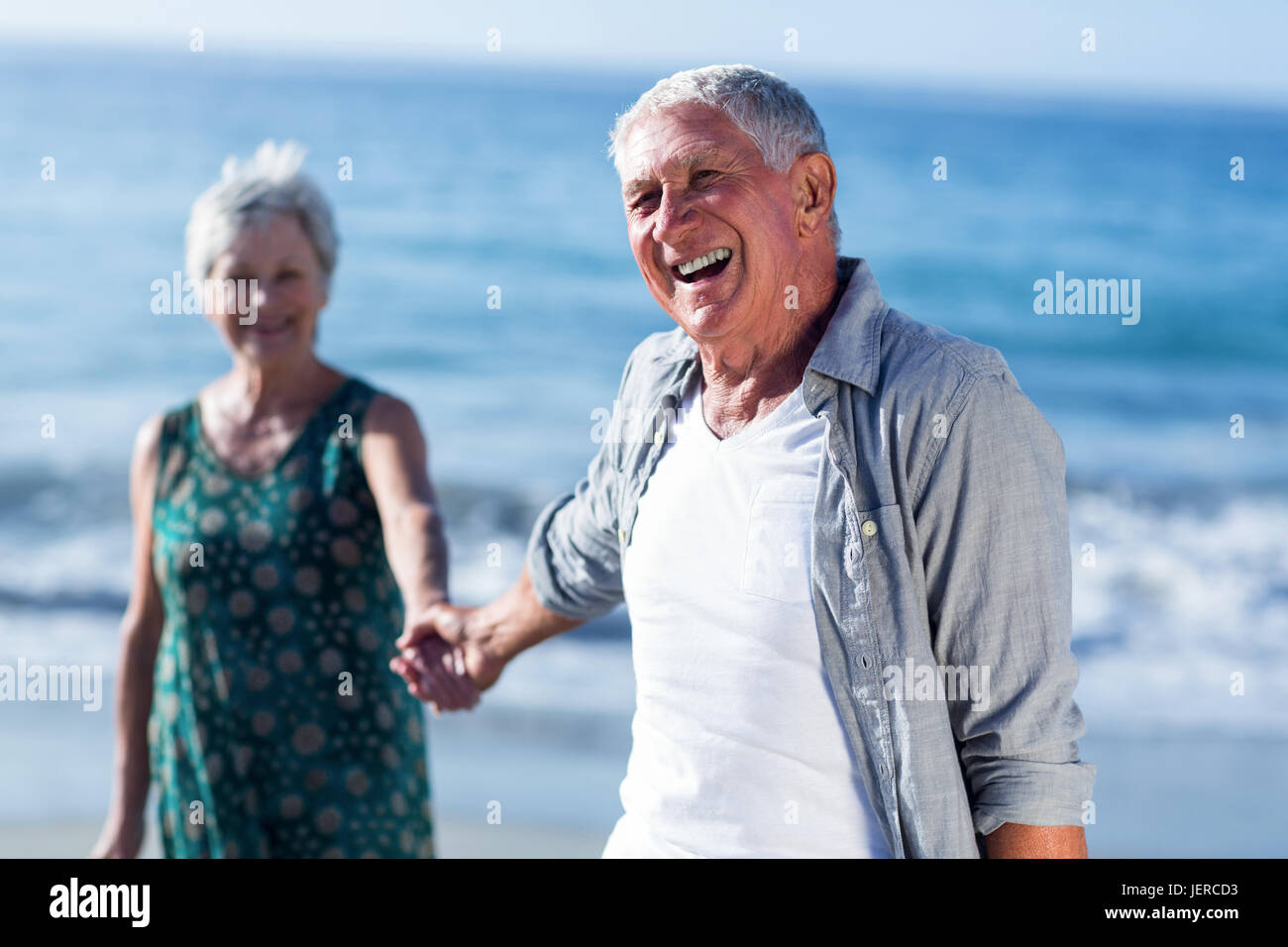 Senior couple holding hands Stock Photo - Alamy