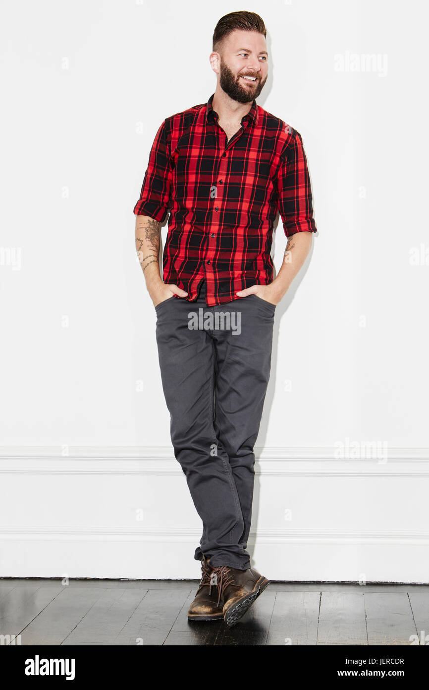 Young man wearing checked shirt, studio shot Stock Photo - Alamy