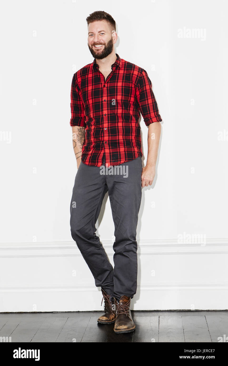 Young man wearing checked shirt, studio shot Stock Photo - Alamy