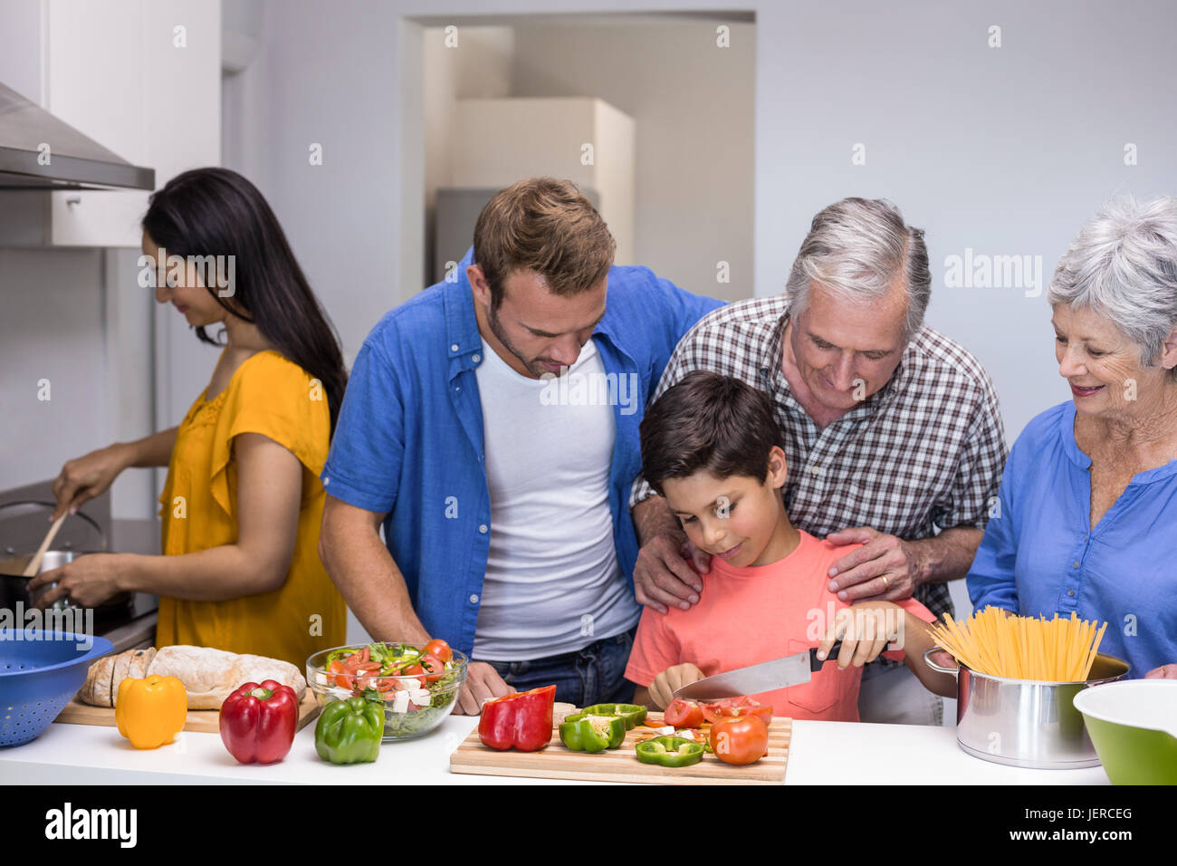 Happy family in the kitchen Stock Photo - Alamy