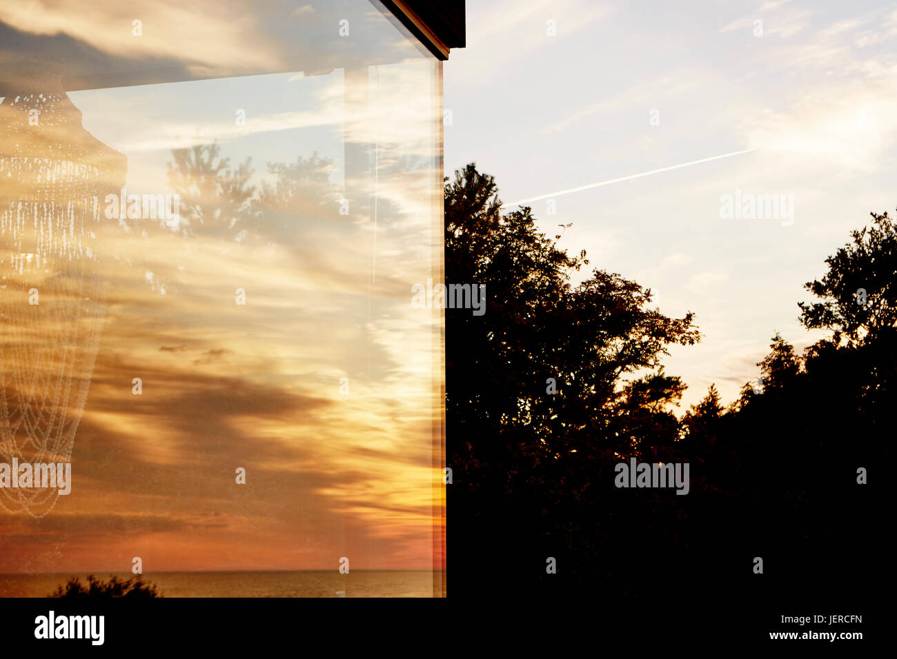Evening light reflecting in window Stock Photo - Alamy