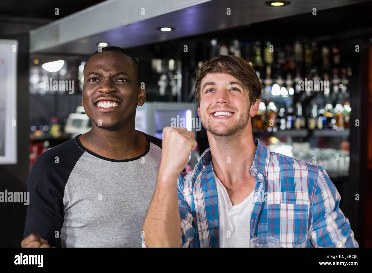 Happy friends watching sport Stock Photo - Alamy