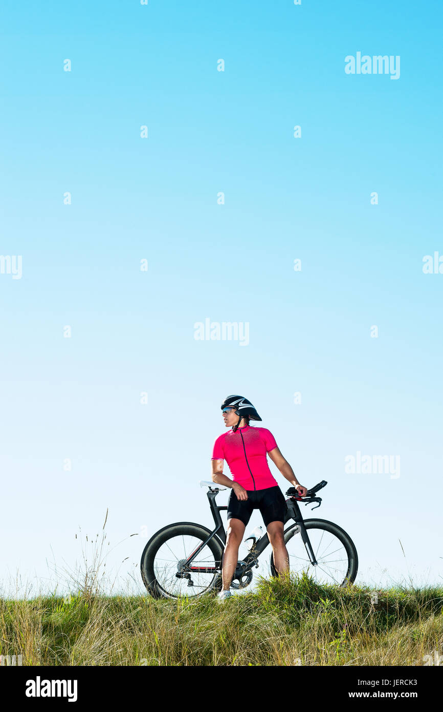 Cyclist standing by bicycle hi-res stock photography and images - Alamy