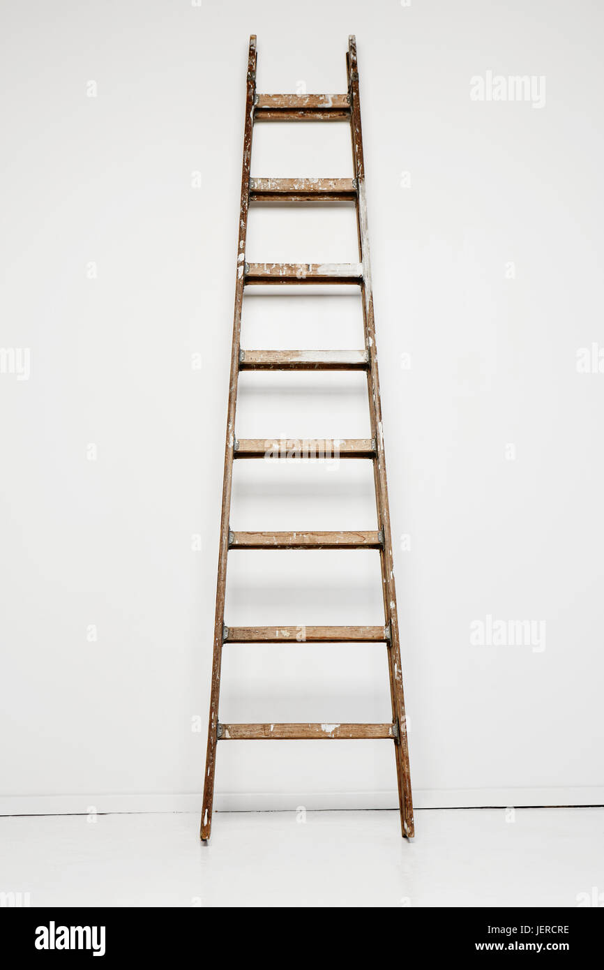 Ladder against white wall Stock Photo - Alamy