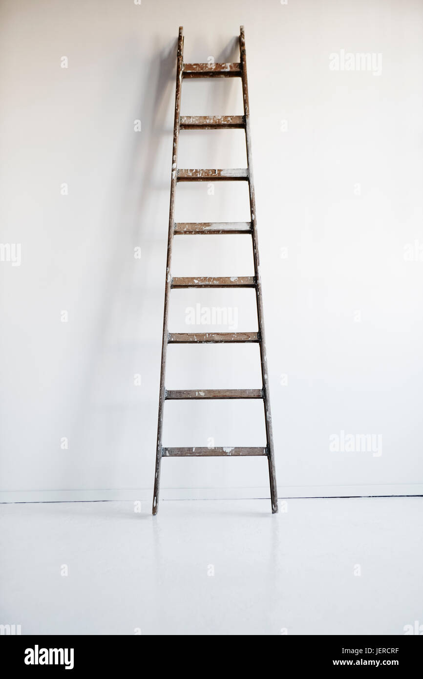Ladder against white wall Stock Photo - Alamy