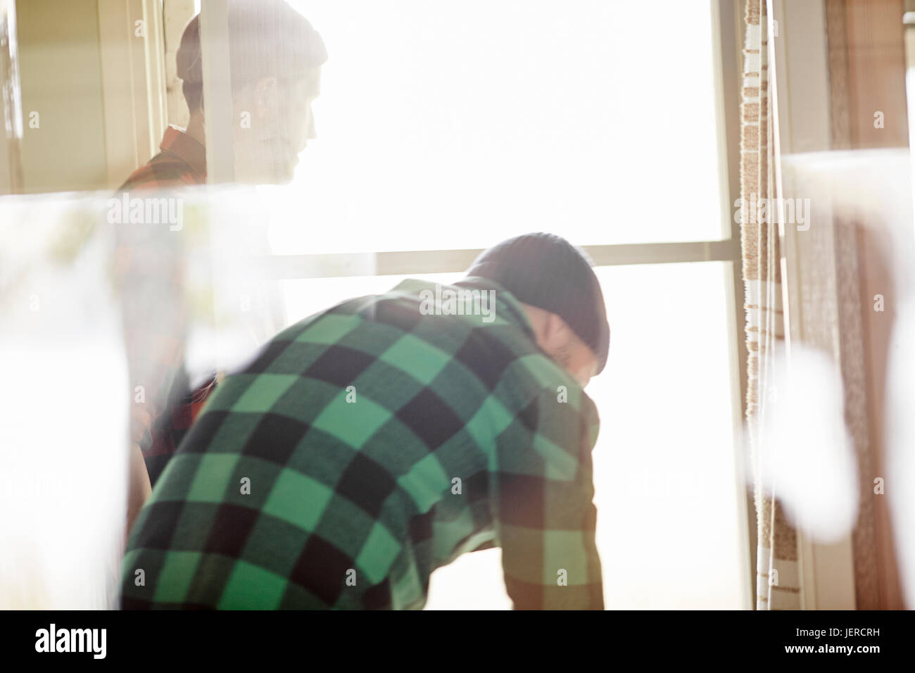Men near window Stock Photo - Alamy