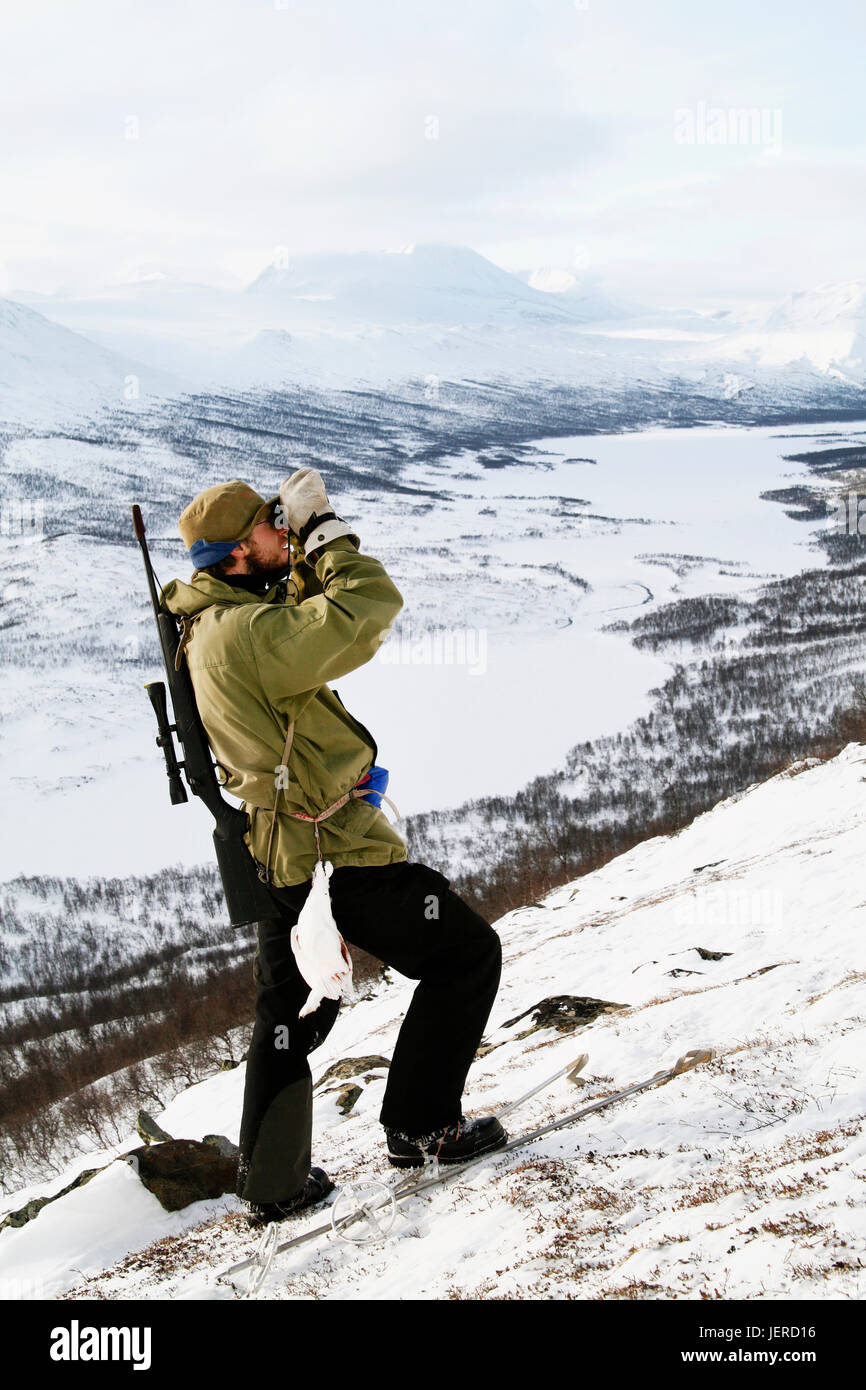 Hunter looking through binoculars Stock Photo - Alamy
