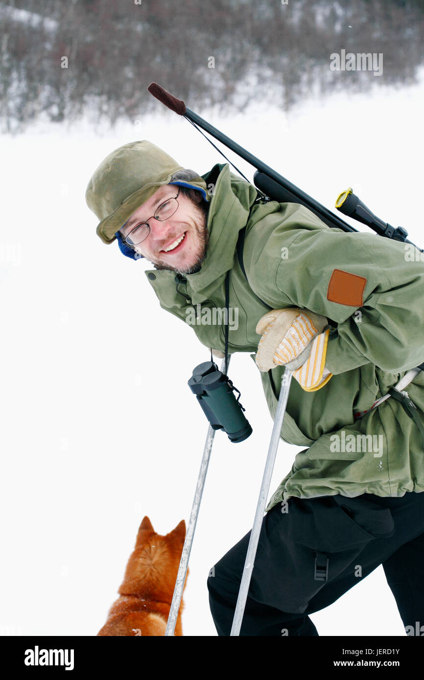 Smiling hunter skiing Stock Photo - Alamy