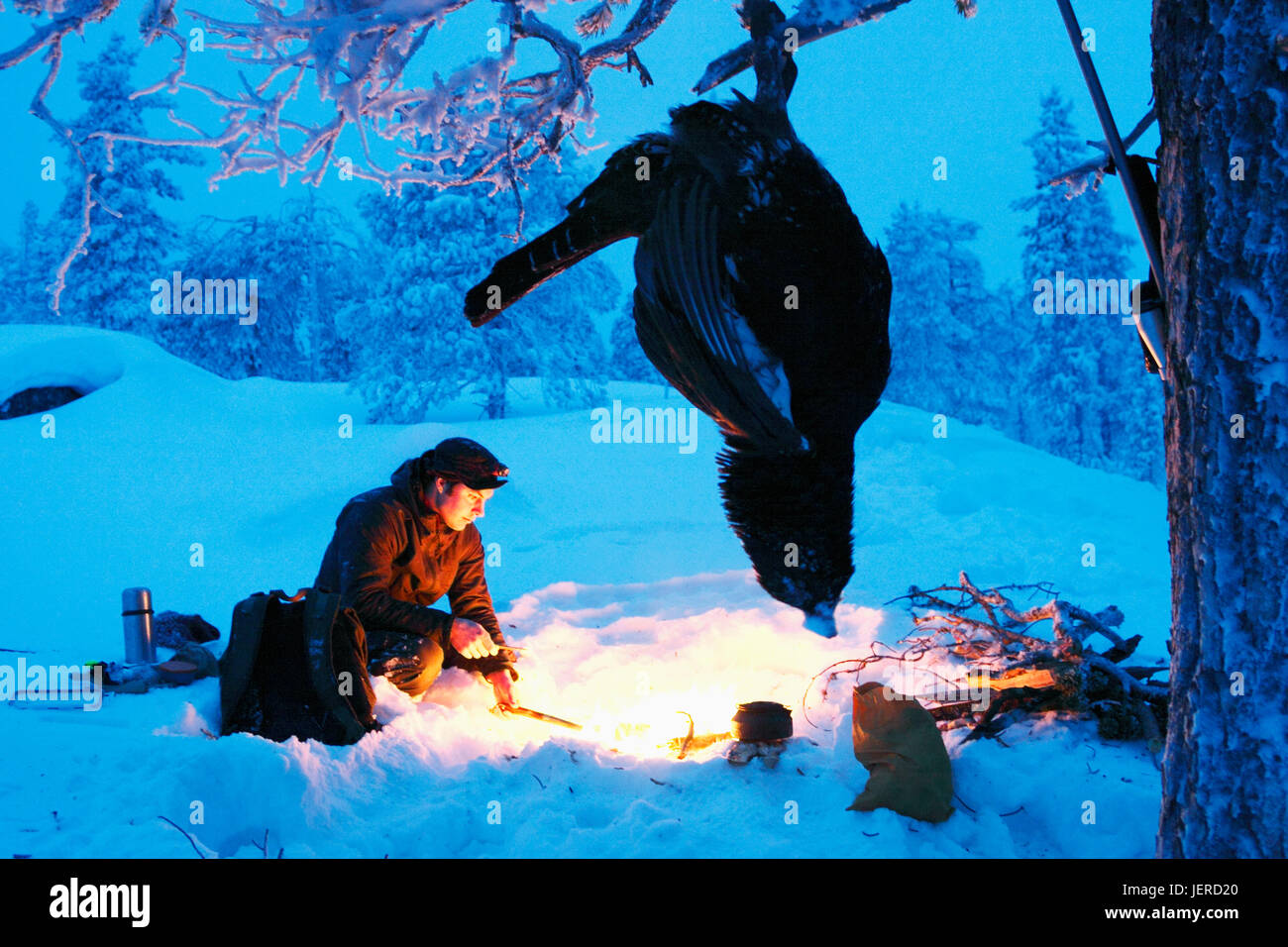 Hunter having fire at dusk Stock Photo - Alamy