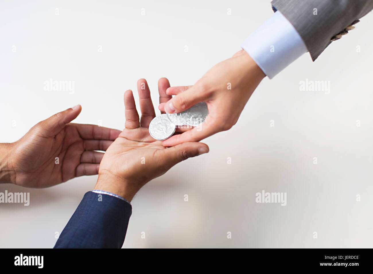 Hands two coins hi-res stock photography and images - Alamy