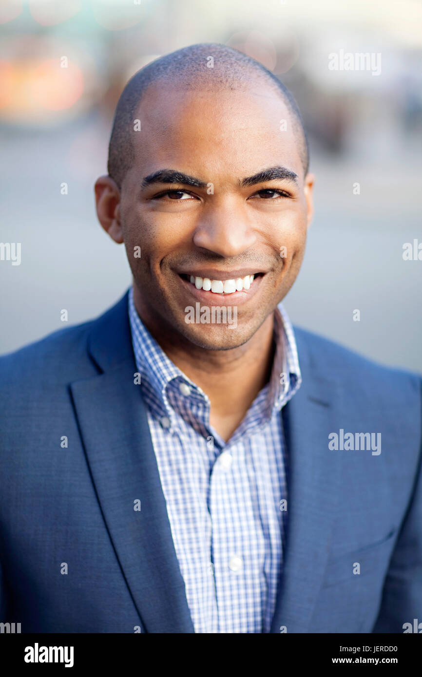 Smiling young man wearing suit Stock Photo - Alamy