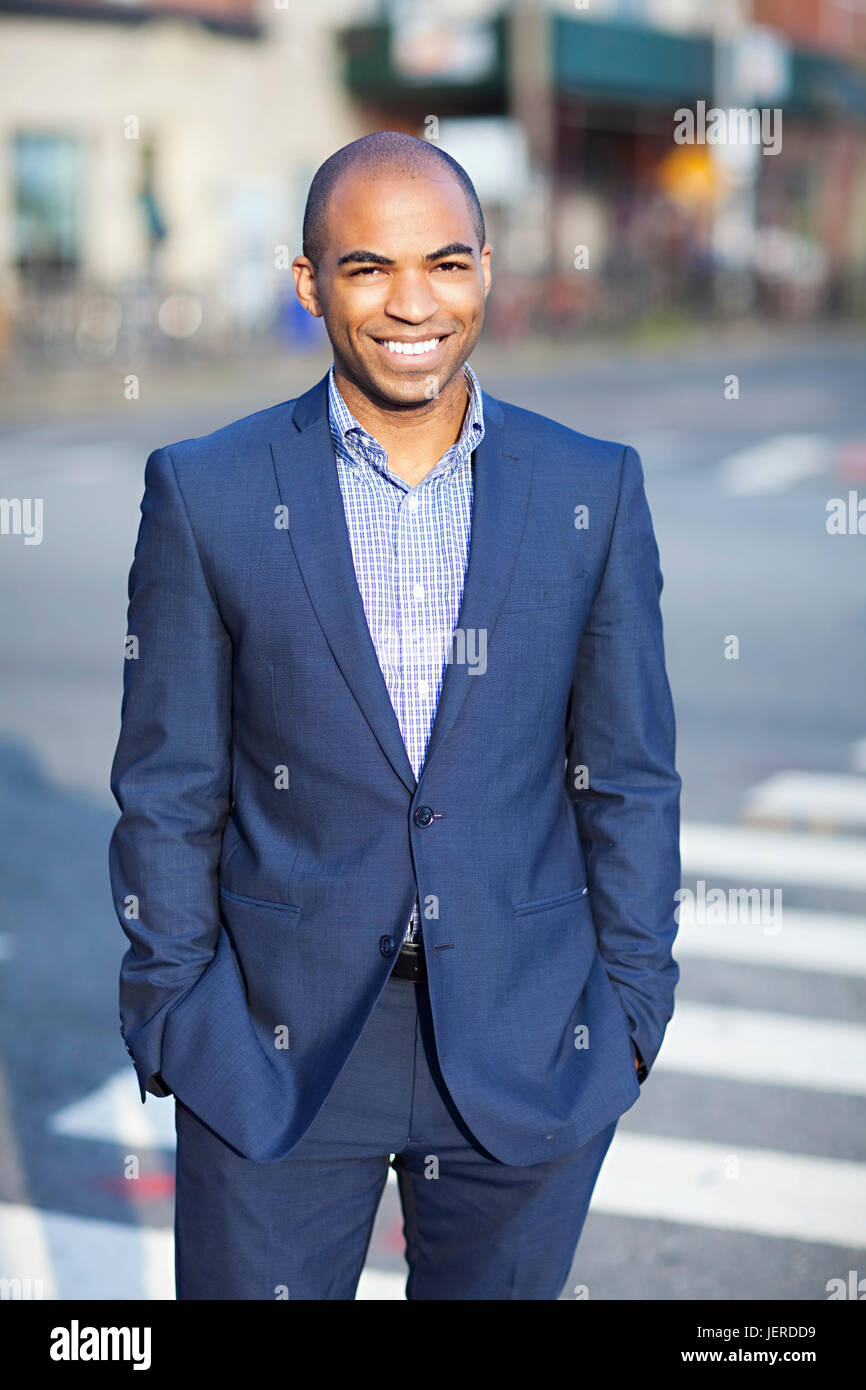 Smiling young man wearing suit Stock Photo - Alamy