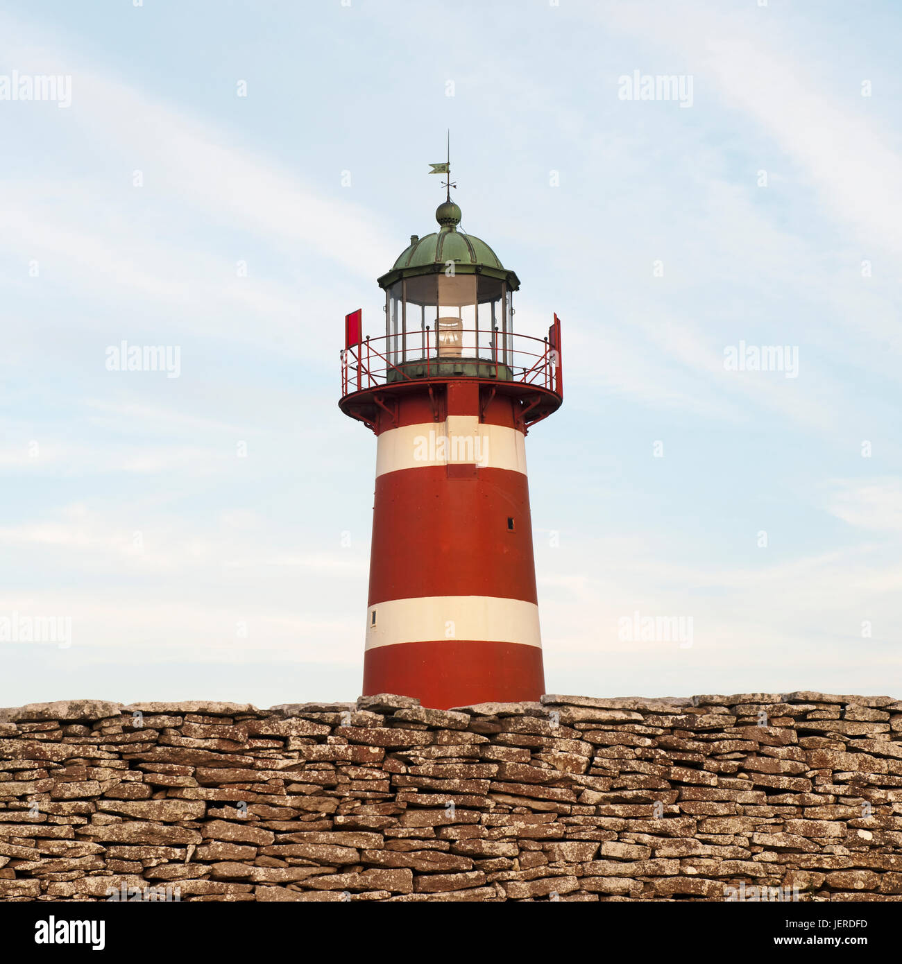Lighthouse, stone wall on foreground Stock Photo - Alamy