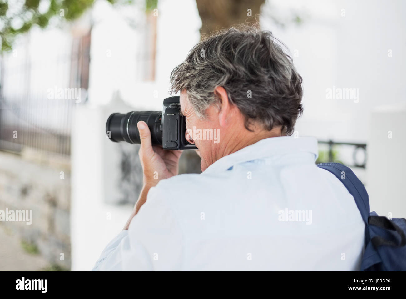 Rear view of man using camera Stock Photo - Alamy
