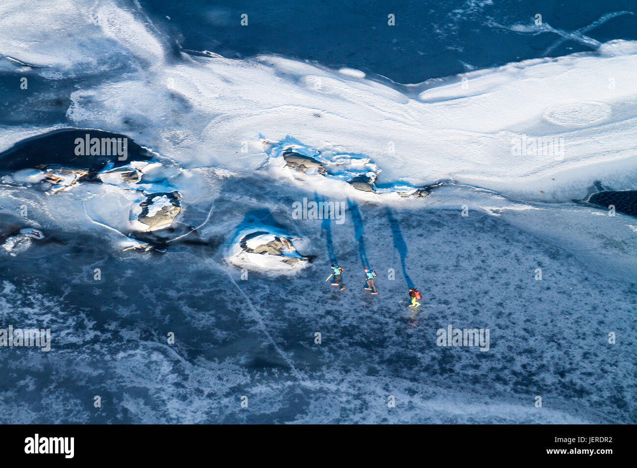 People ice-skating on frozen water Stock Photo - Alamy