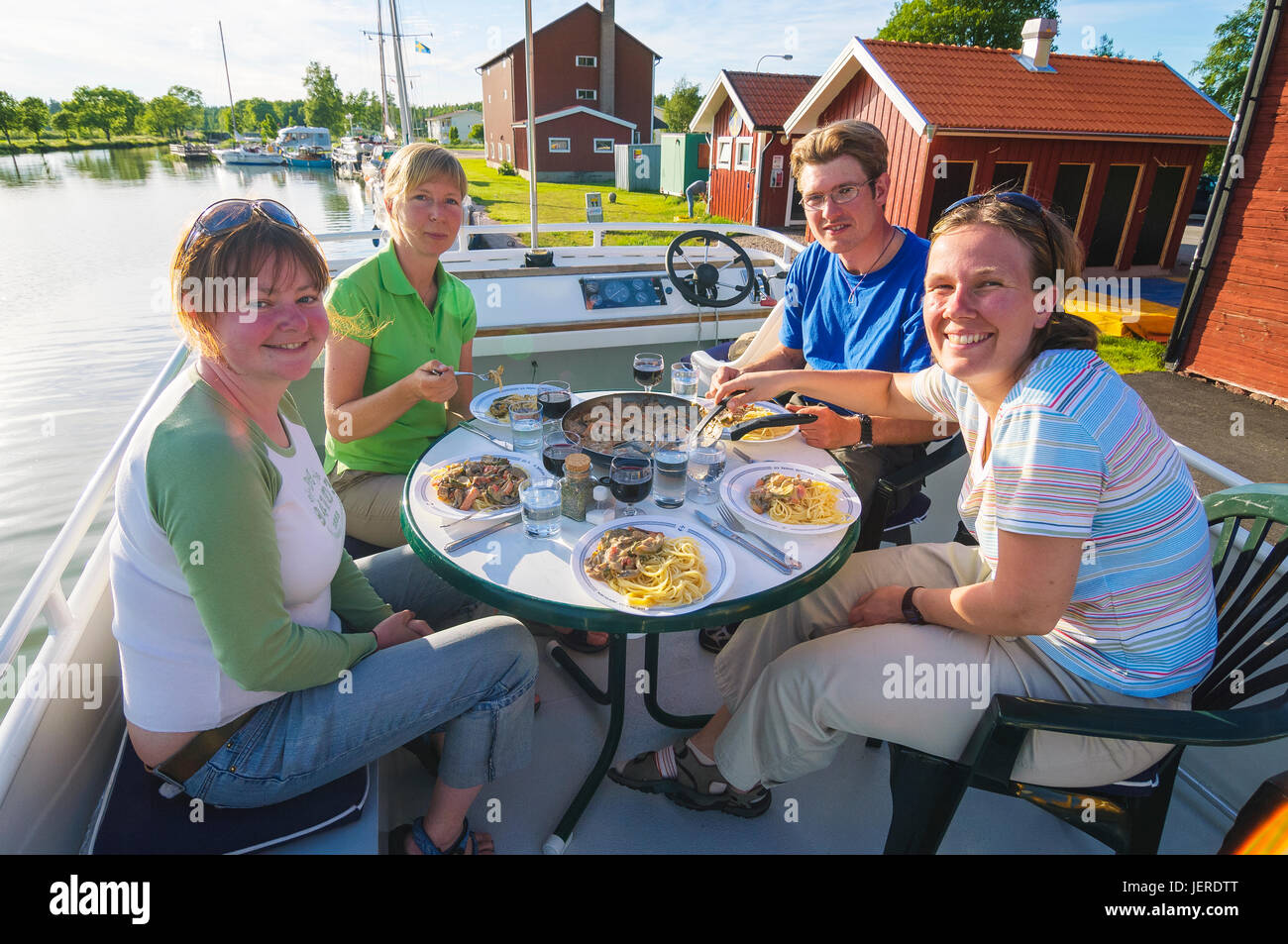 Friends having meal on boat Stock Photo - Alamy