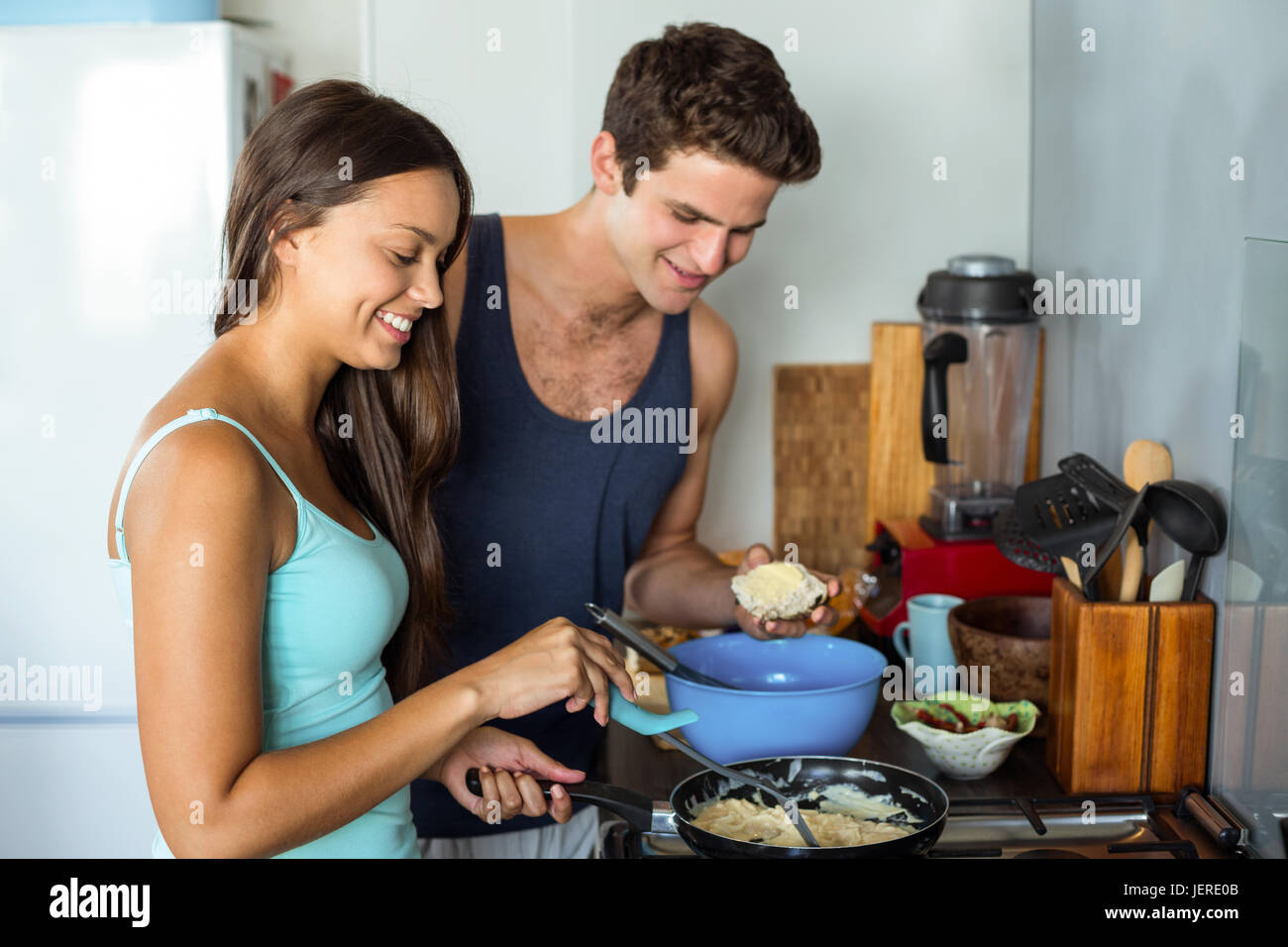 Couple cooking food in kitchen at home Stock Photo - Alamy