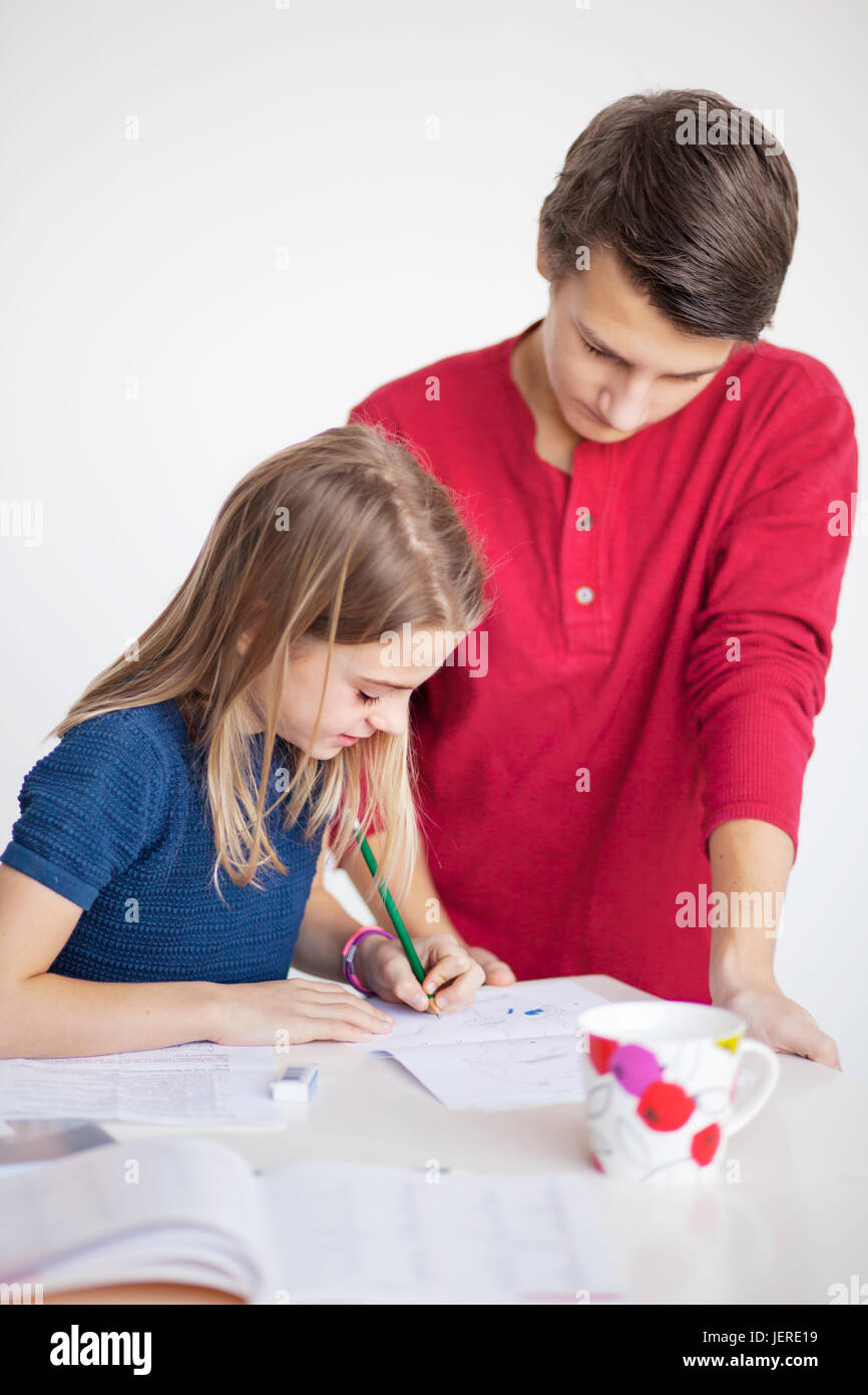Teenager helping homework sister hi-res stock photography and images ...