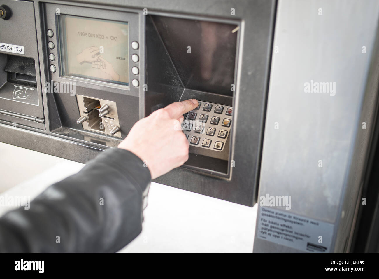Woman using cash machine Stock Photo - Alamy