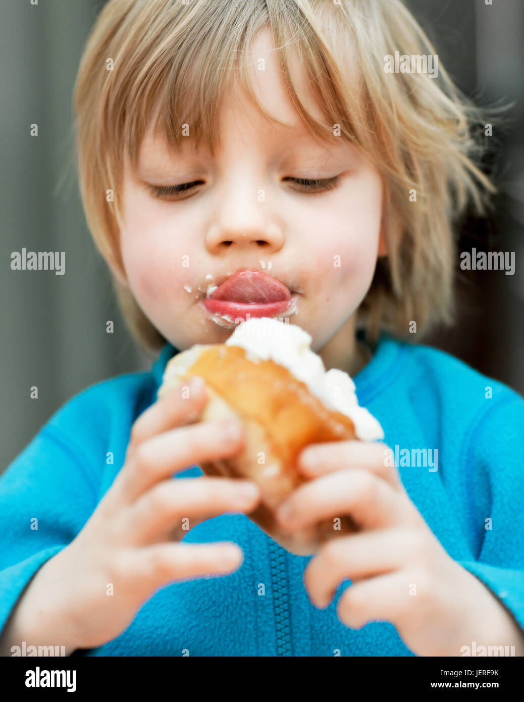 Boy eating bun Stock Photo - Alamy