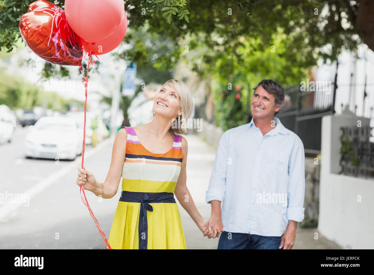 Happy couple with balloon Stock Photo - Alamy