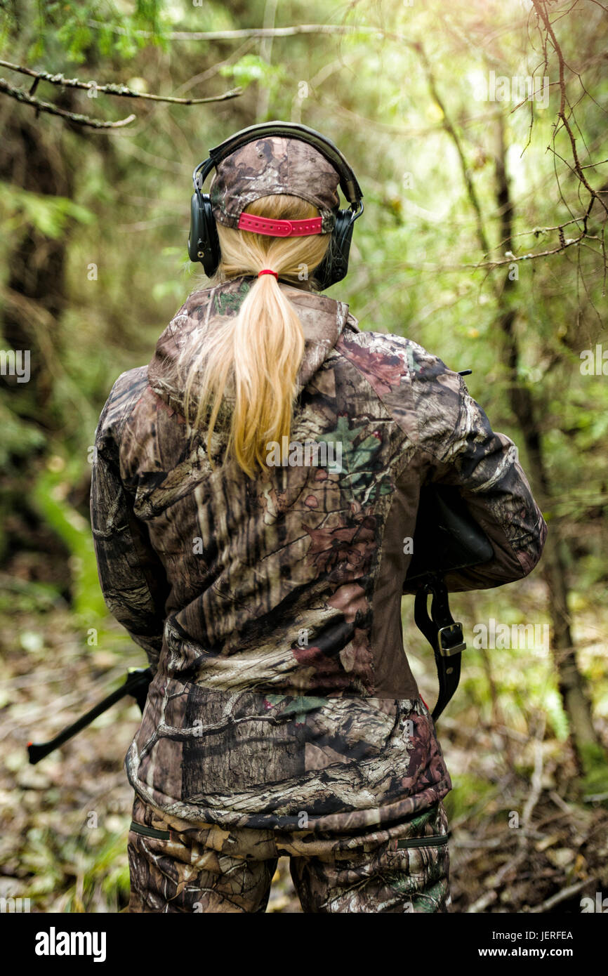 Woman hunting in forest Stock Photo - Alamy