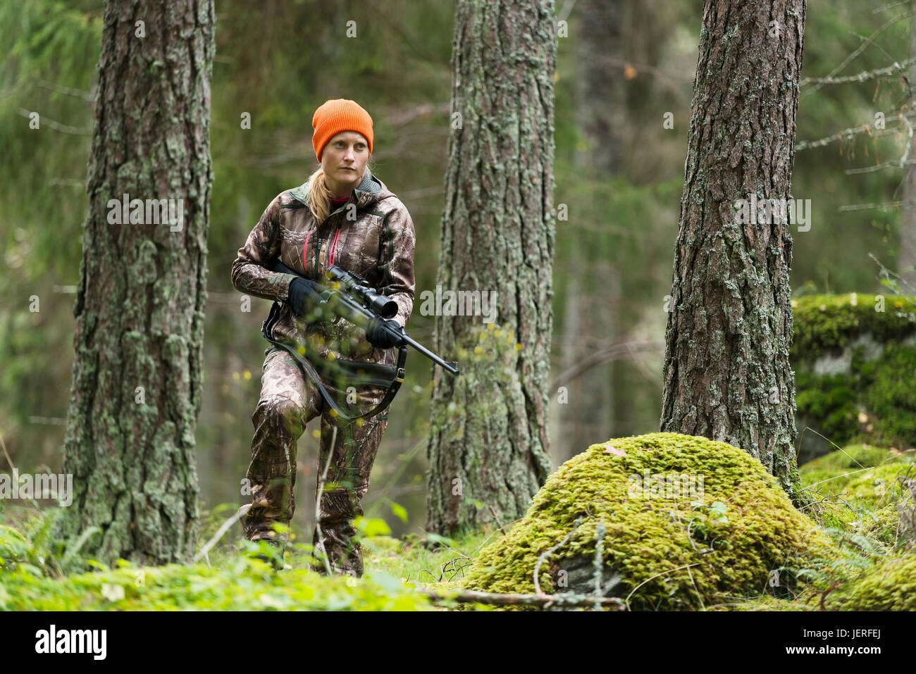 Woman hunting in forest Stock Photo - Alamy