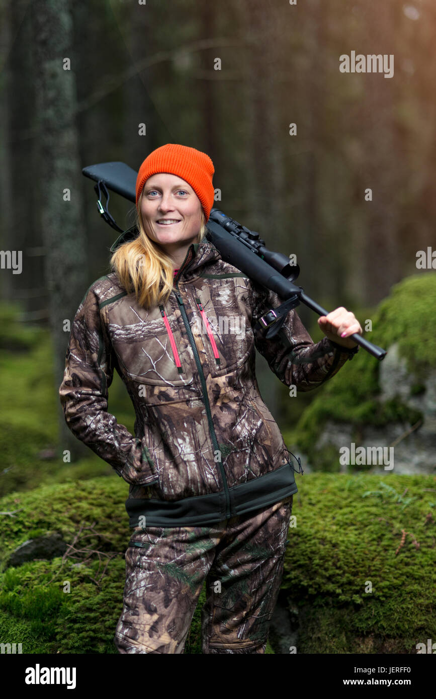 Woman hunting in forest Stock Photo - Alamy