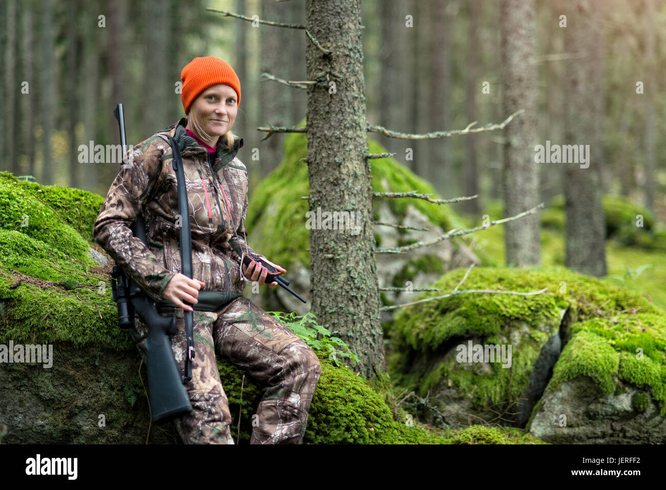Woman hunting in forest Stock Photo - Alamy