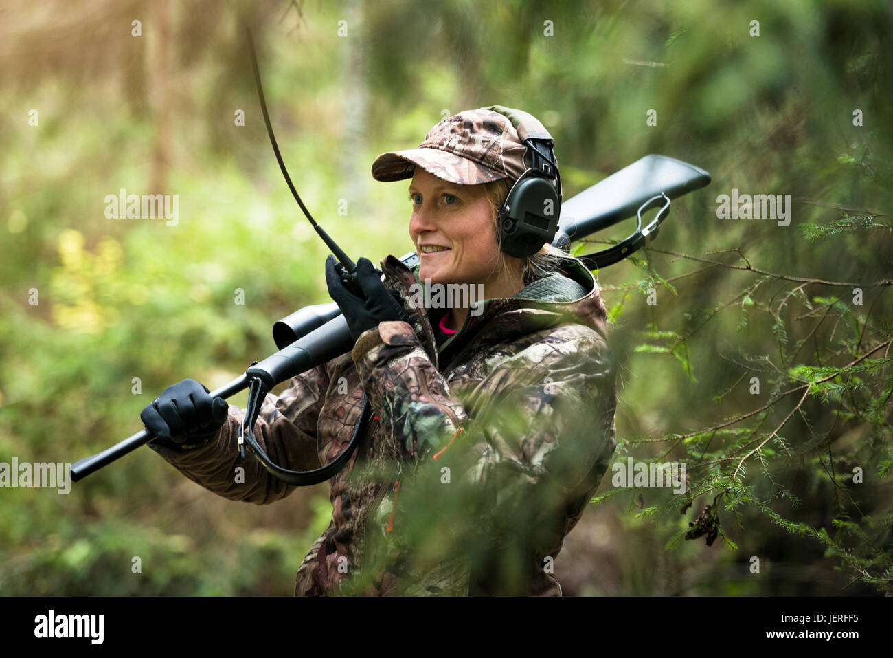 Woman hunting in forest Stock Photo - Alamy