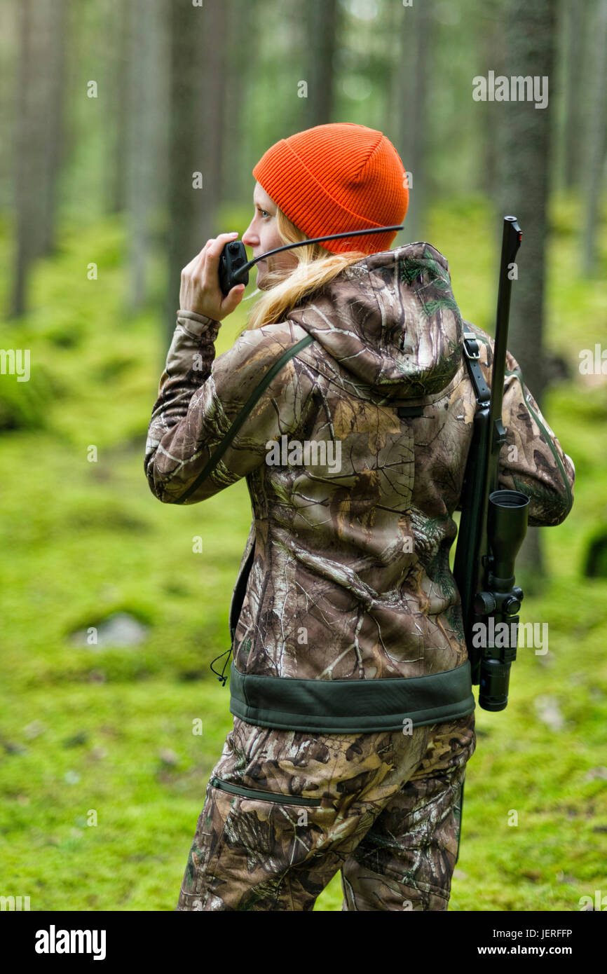 Woman hunting in forest Stock Photo - Alamy