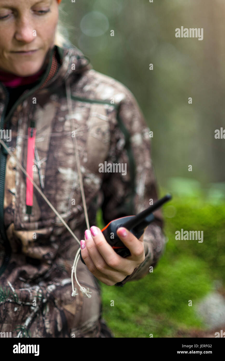 Woman hunting in forest Stock Photo - Alamy