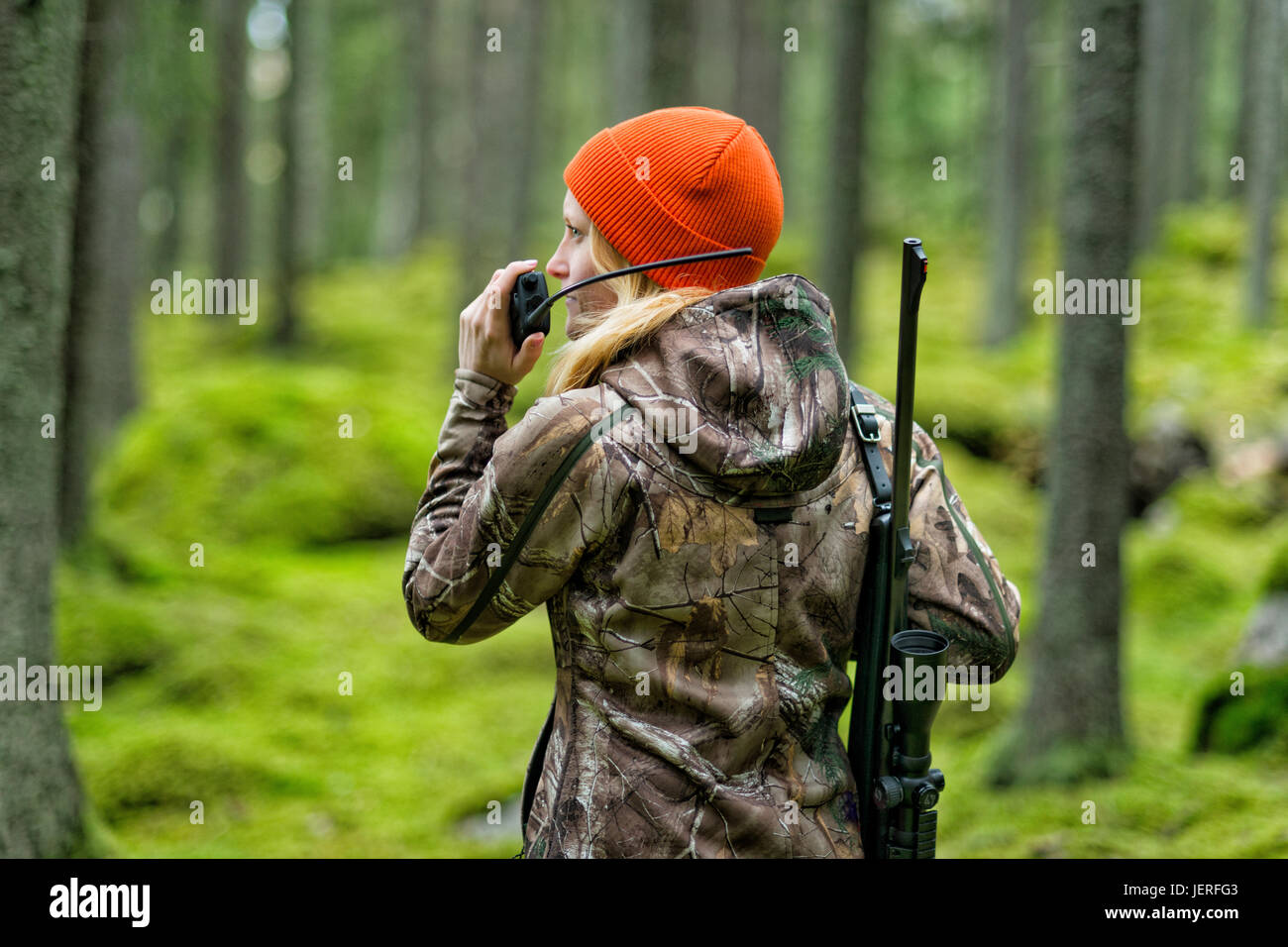 Woman hunting in forest Stock Photo - Alamy