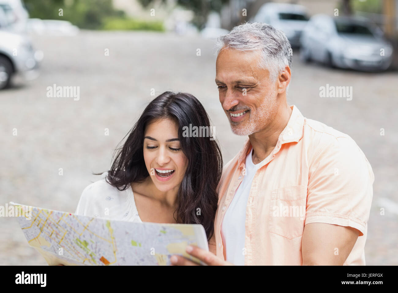 Couple reading map Stock Photo - Alamy