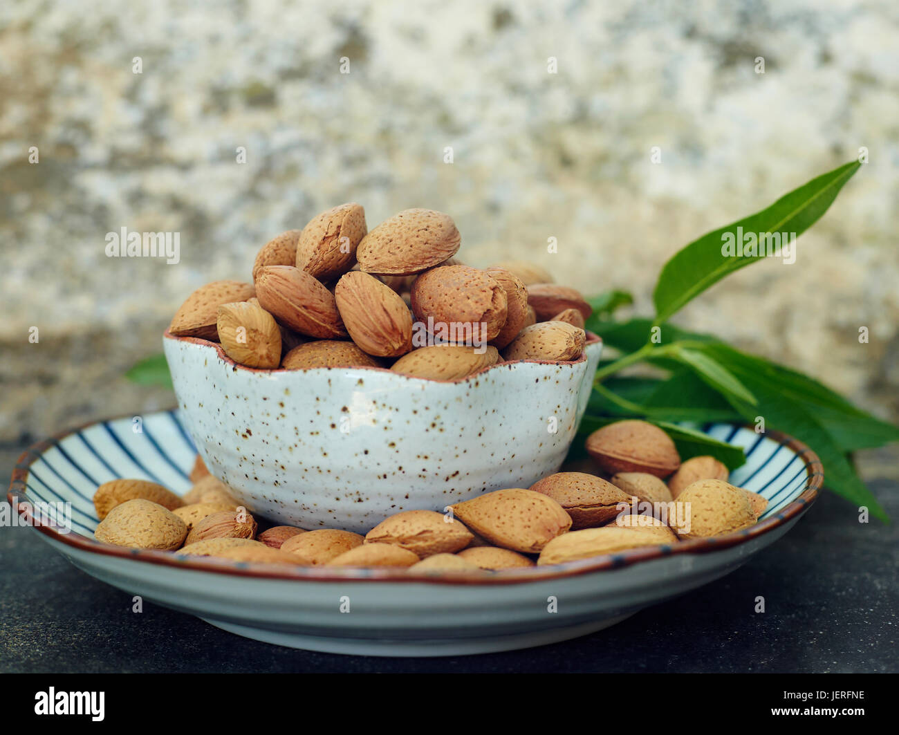Almonds in bowl Stock Photo - Alamy