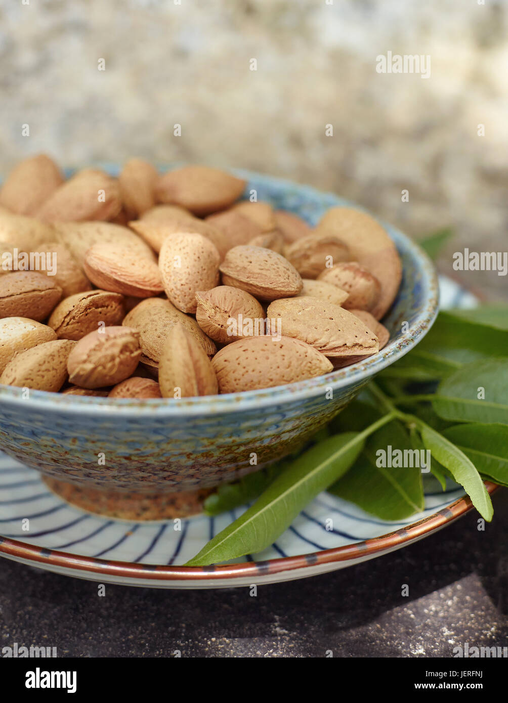 Almonds in bowl Stock Photo - Alamy