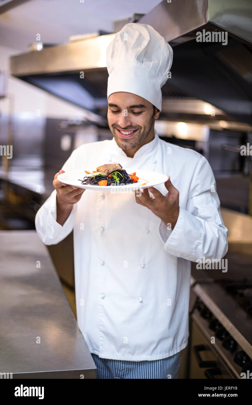 Handsome chef presenting meal Stock Photo - Alamy