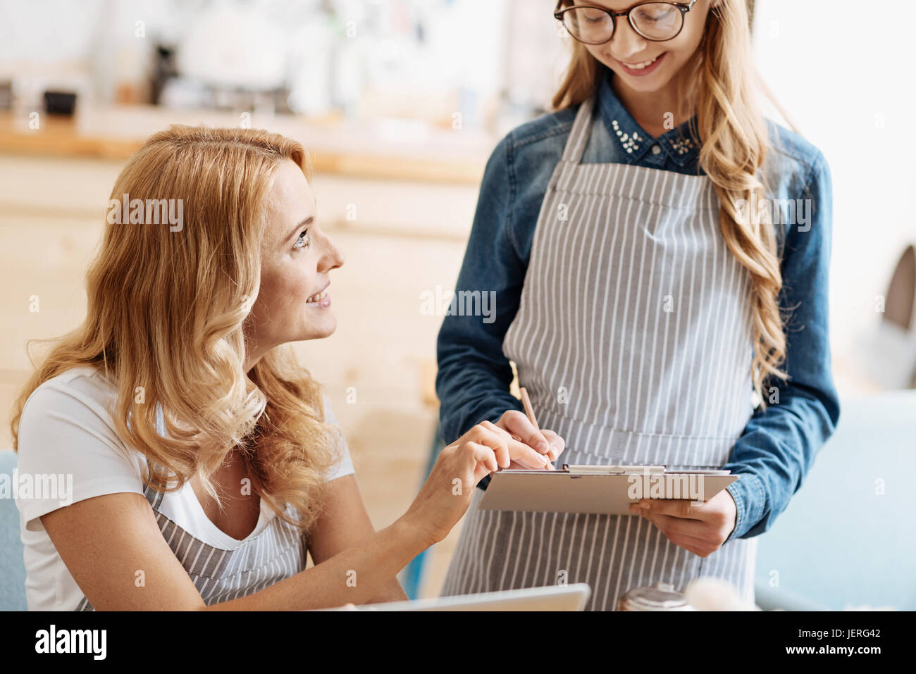 Mother pointing at an important place in daughters notes Stock Photo ...