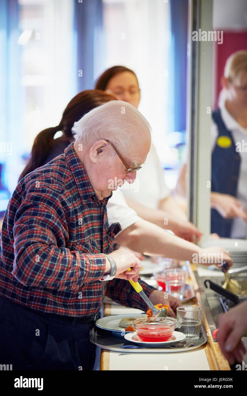 Senior man taking lunch Stock Photo - Alamy