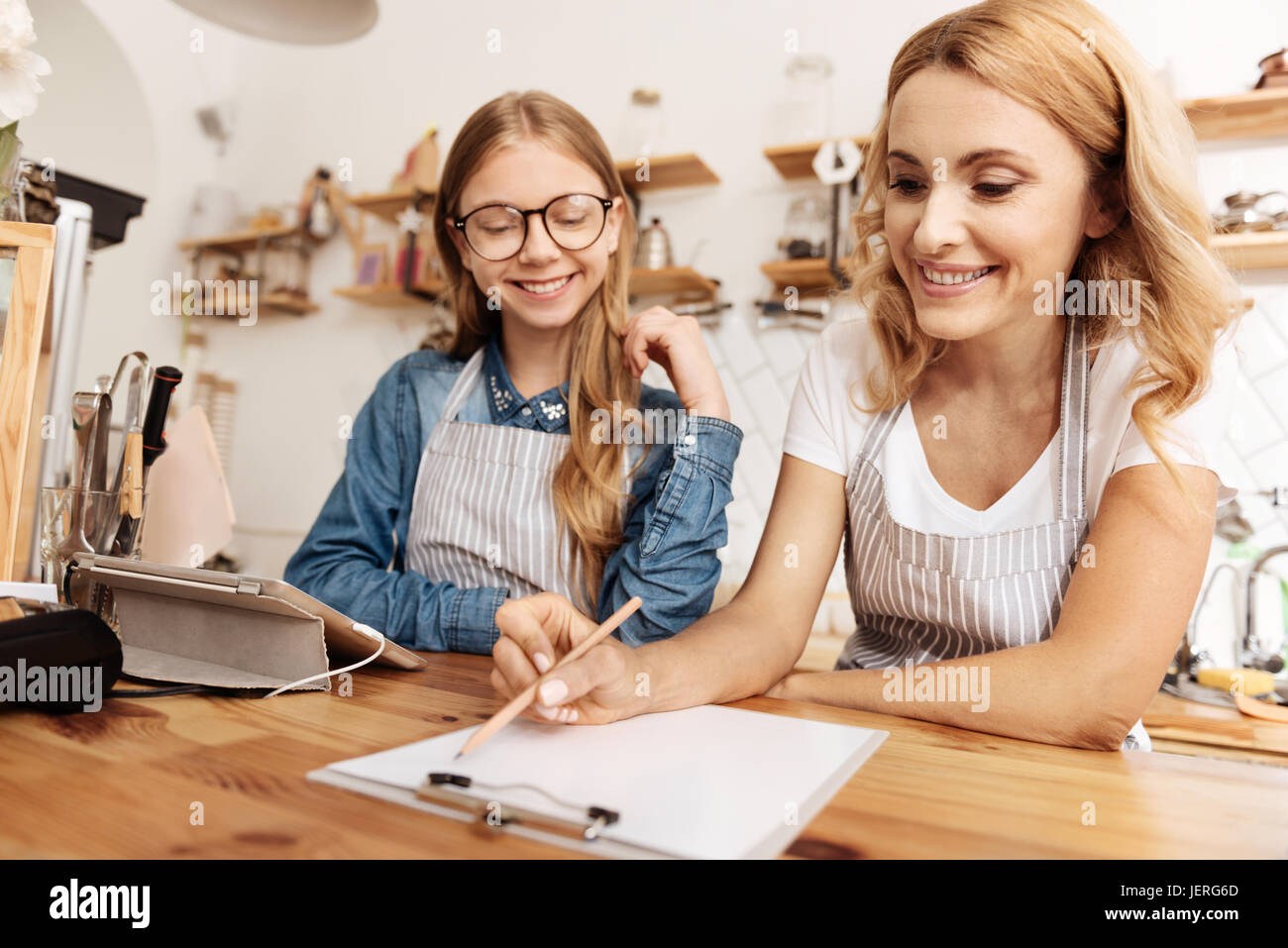 Caring mother sharing her cafe management experience with daughter ...